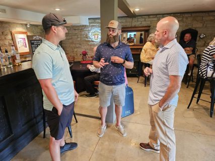 President Rob DeHoff (right) talks with two potential members.
